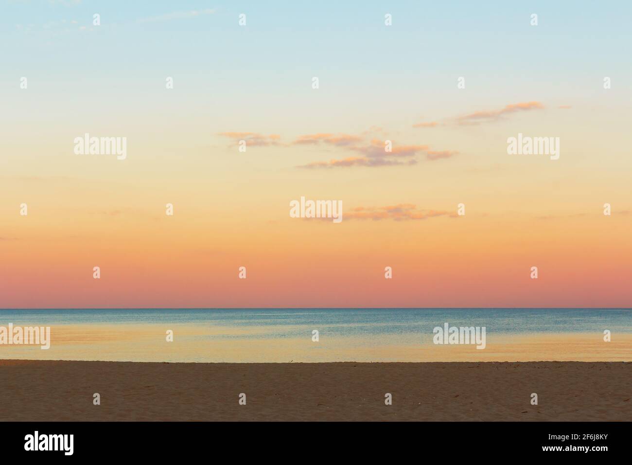 Calmness seaside . Calm sea water surface view from the beach . Dawn ...