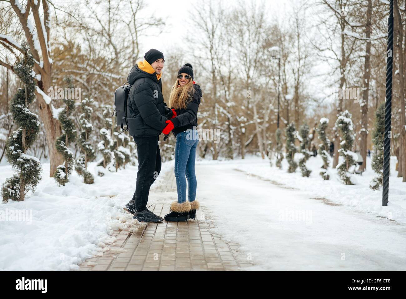Young happy couple in love having a walk in a winter park Stock Photo ...