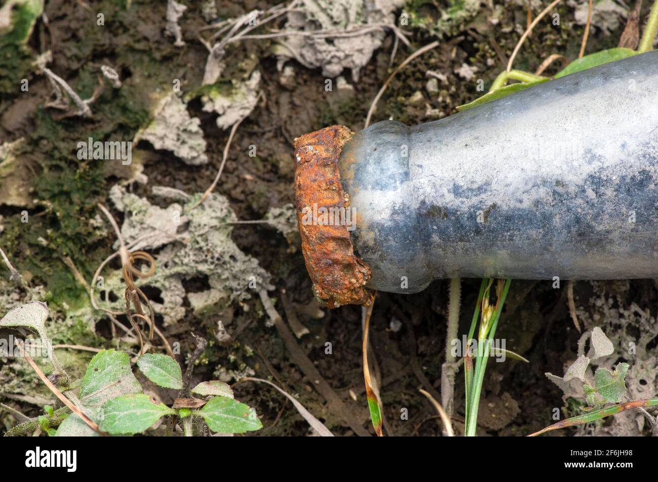 The rusty bottle cap is still in place, on the dirty ground Stock Photo ...