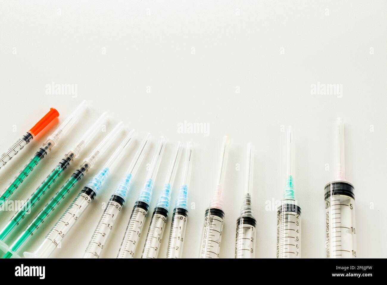 Set of medical empty needles, big and insulin needles on the white ...