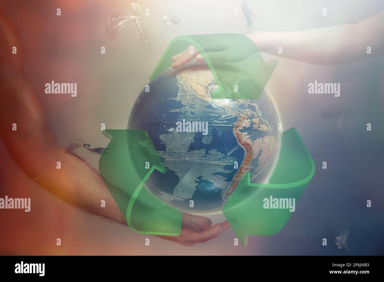 Women's and men's hands support the globe of planet Earth with sign of ...
