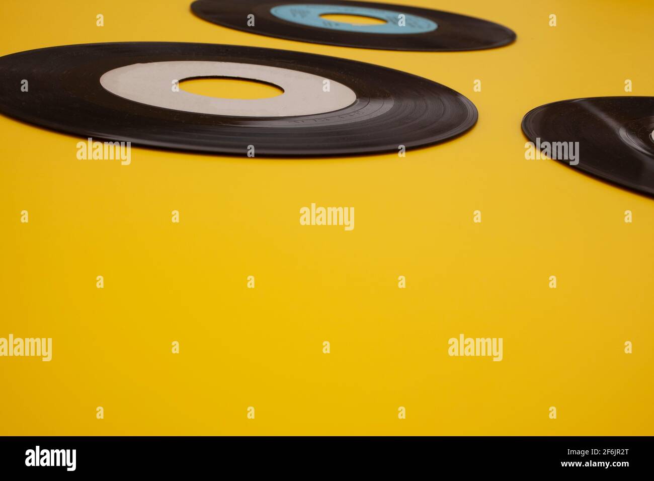 Old Vinyl 45 rpm Records on yellow background Stock Photo - Alamy
