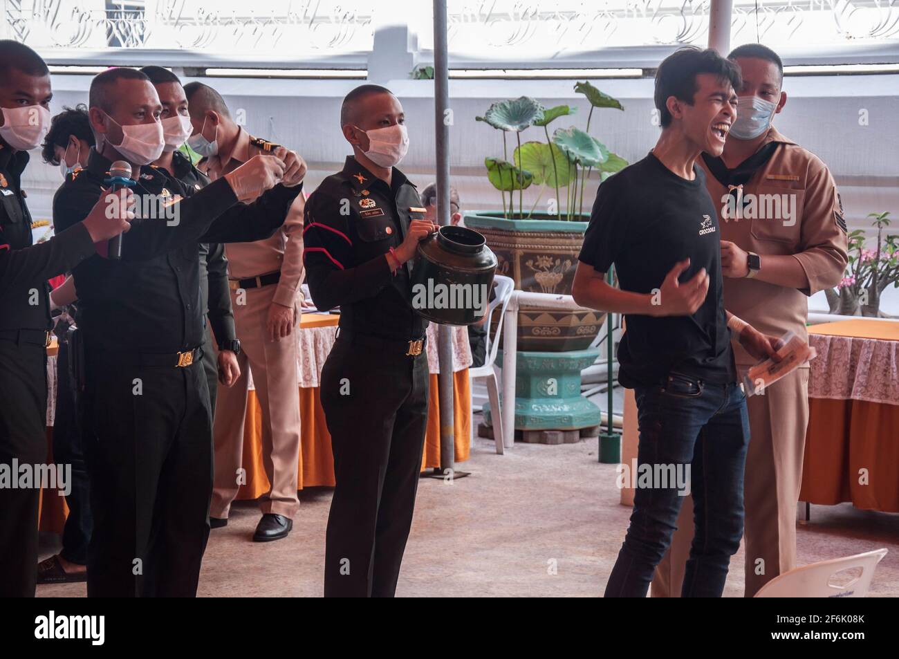 A Thai man celebrates after drawing a 'black card' from a lottery to be ...