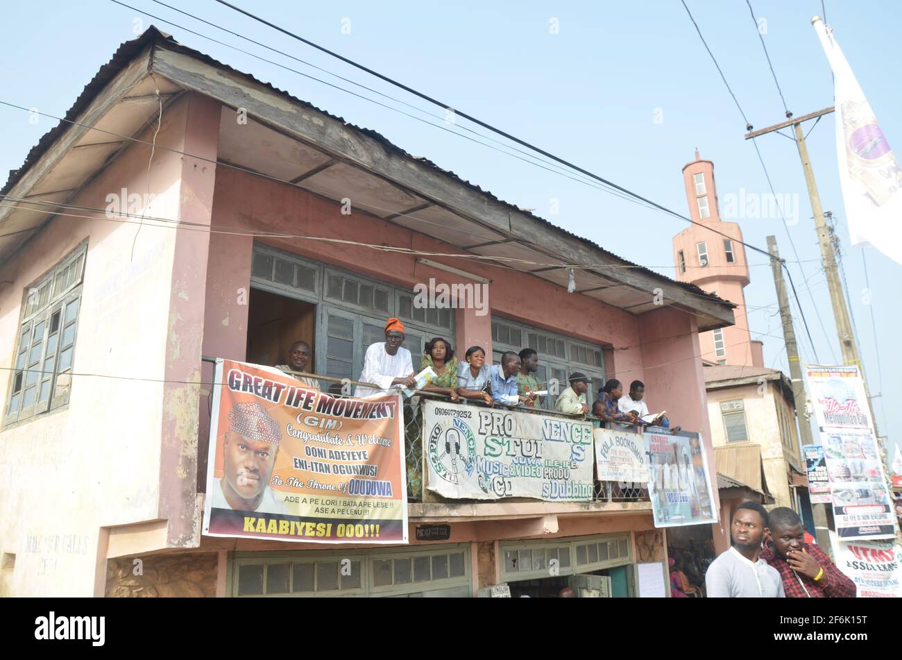 A young man looking at the portrait of Ooni of Ife, Oba Adeyeye Enitan ...