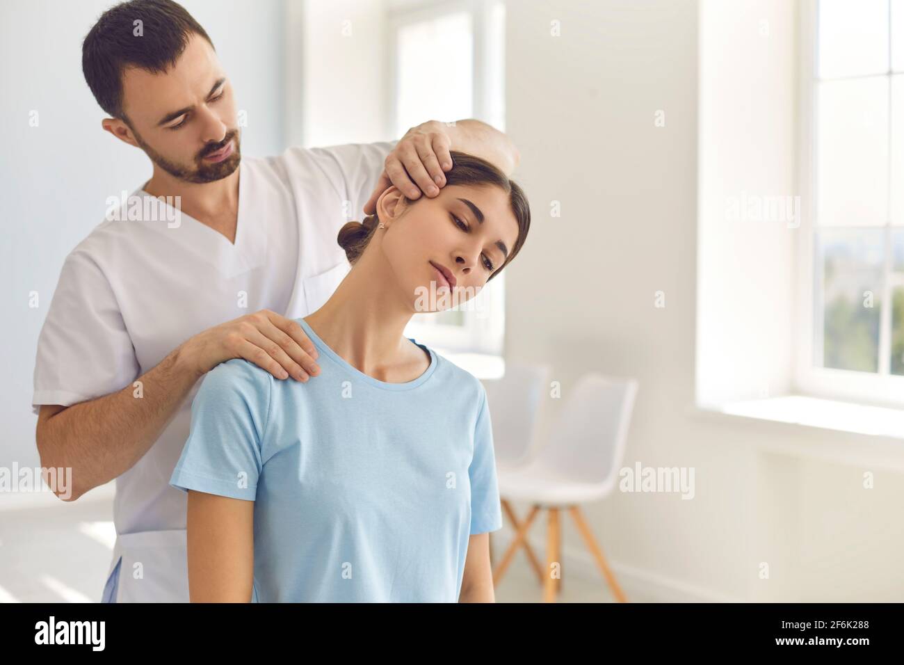 Professional osteopath during work fixing womans neck Stock Photo - Alamy