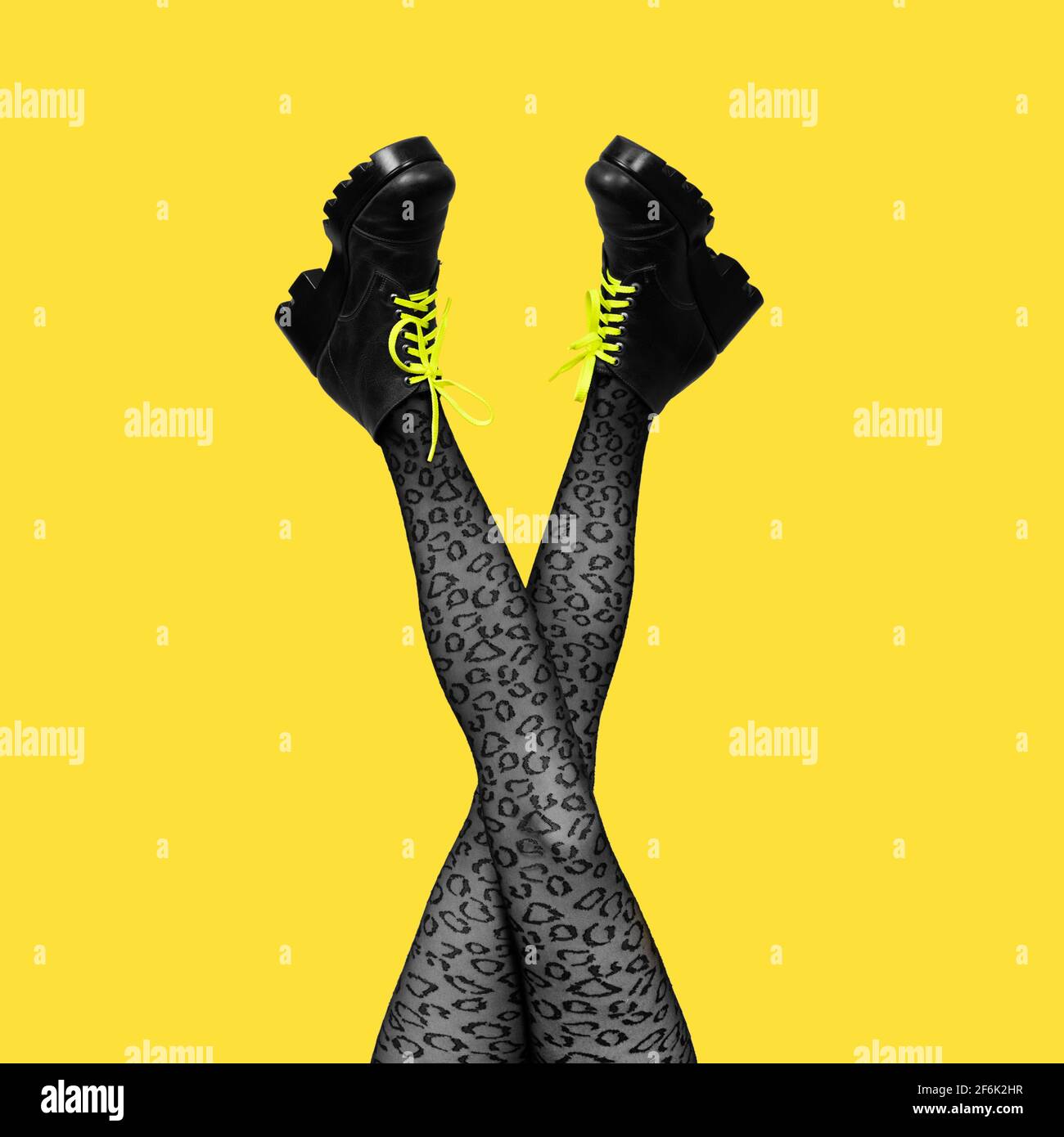 New gray female boots with bright yellow laces on long slender crossed ...