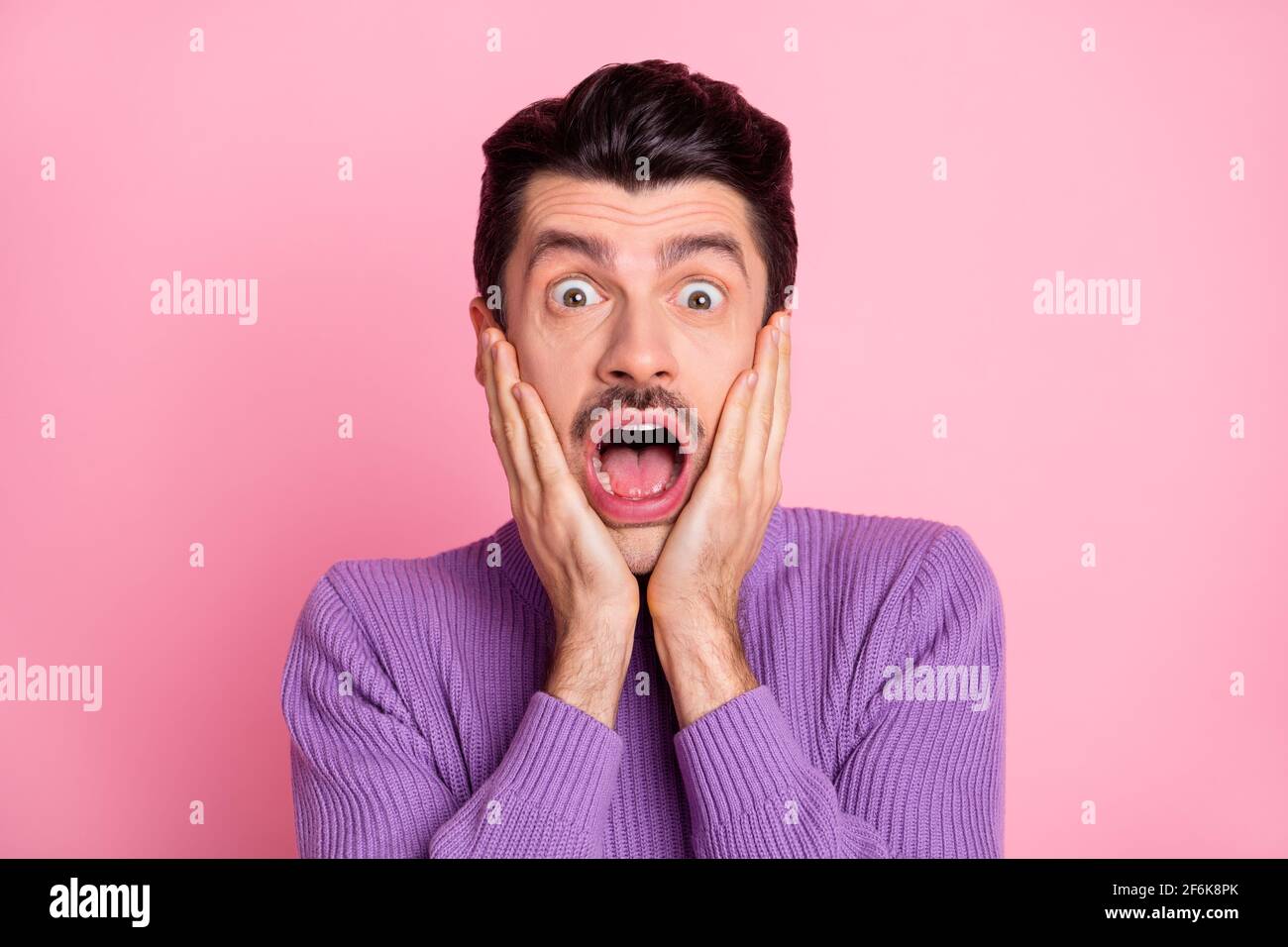 Photo Of Upset Impressed Young Guy Wear Violet Sweater Arms Cheeks Open