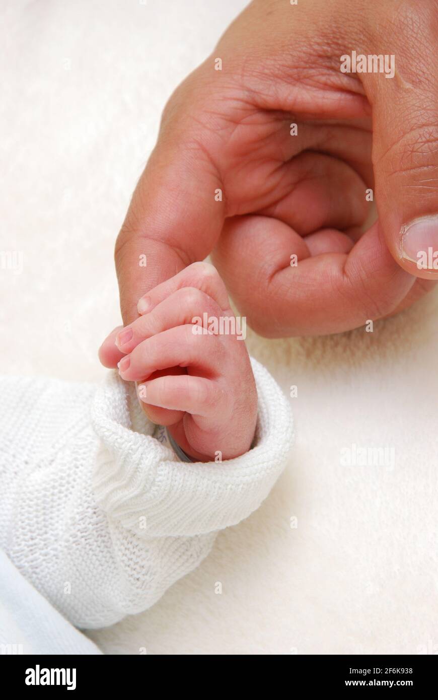 small baby hand catch his father's hand Stock Photo - Alamy