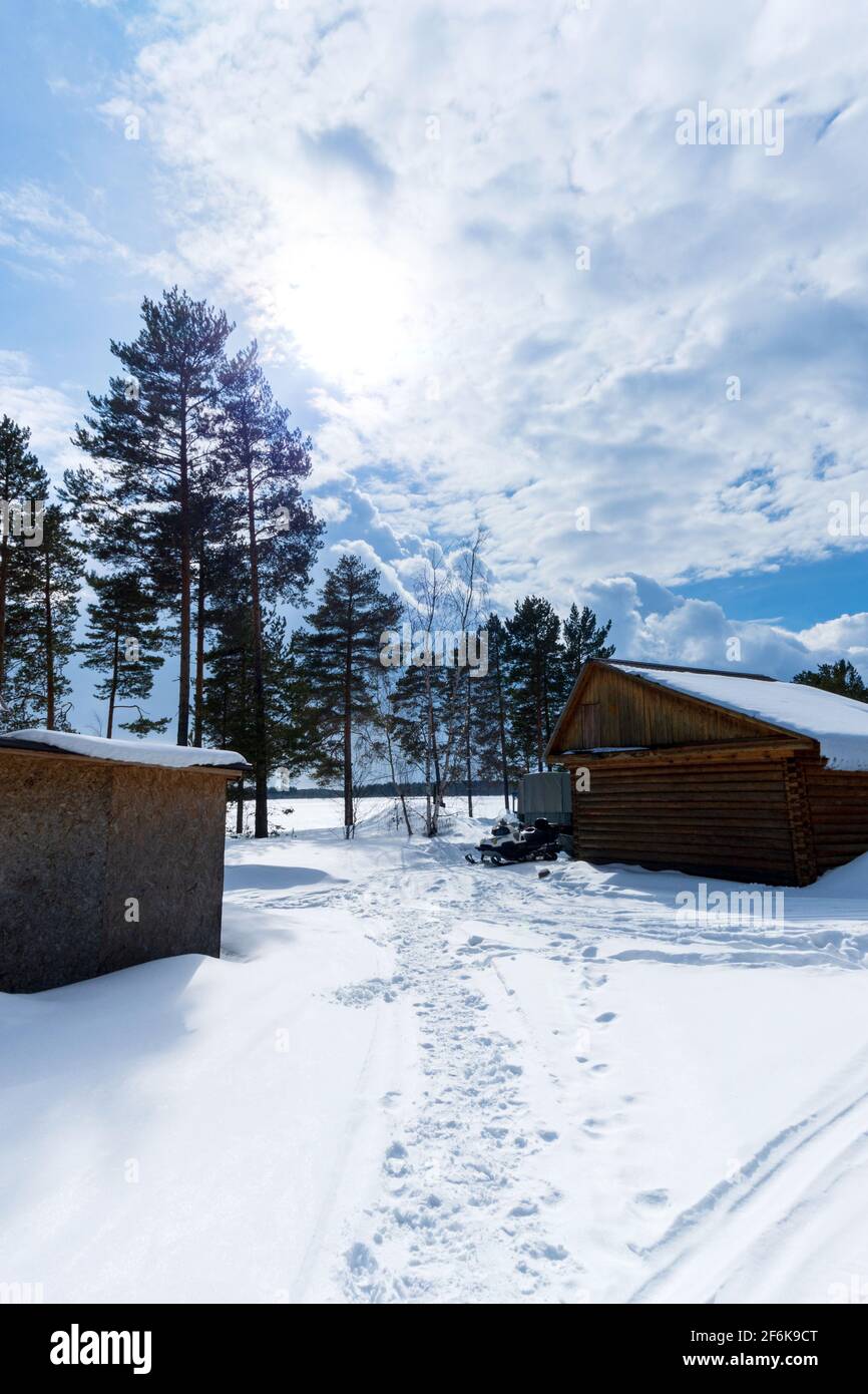 landscape winter photo in the forest with wooden houses. fishing houses ...