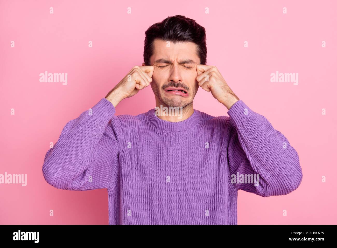 Portrait of attractive sad depressed guy crying wiping tears isolated ...