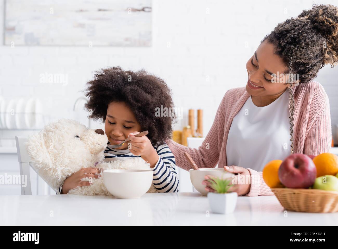 Child feeding the teddy bear hi-res stock photography and images - Alamy