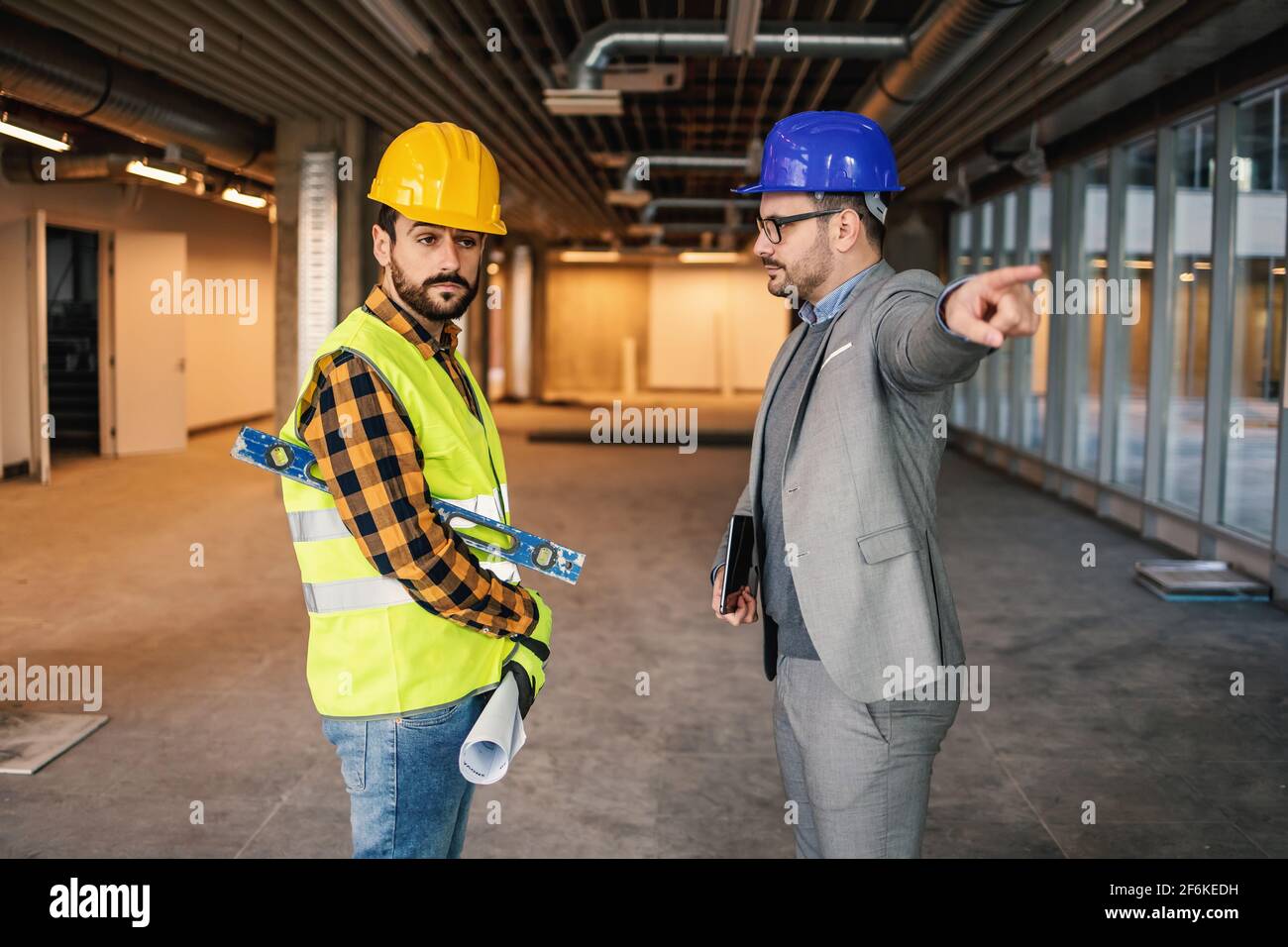 Angry supervisor getting fired construction worker. Construction site ...