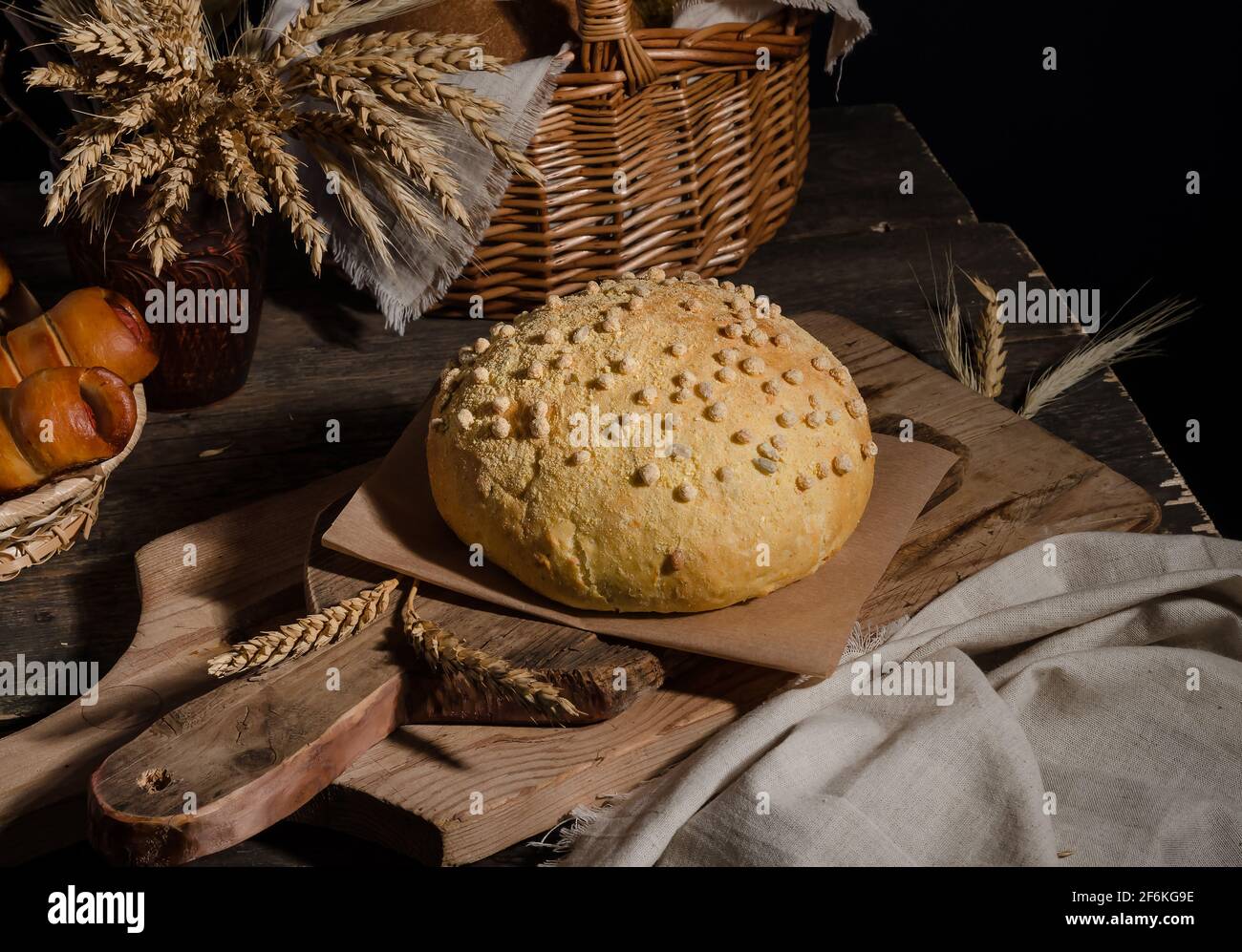 Beautiful loaf of white bread with a curly top on a wooden background ...