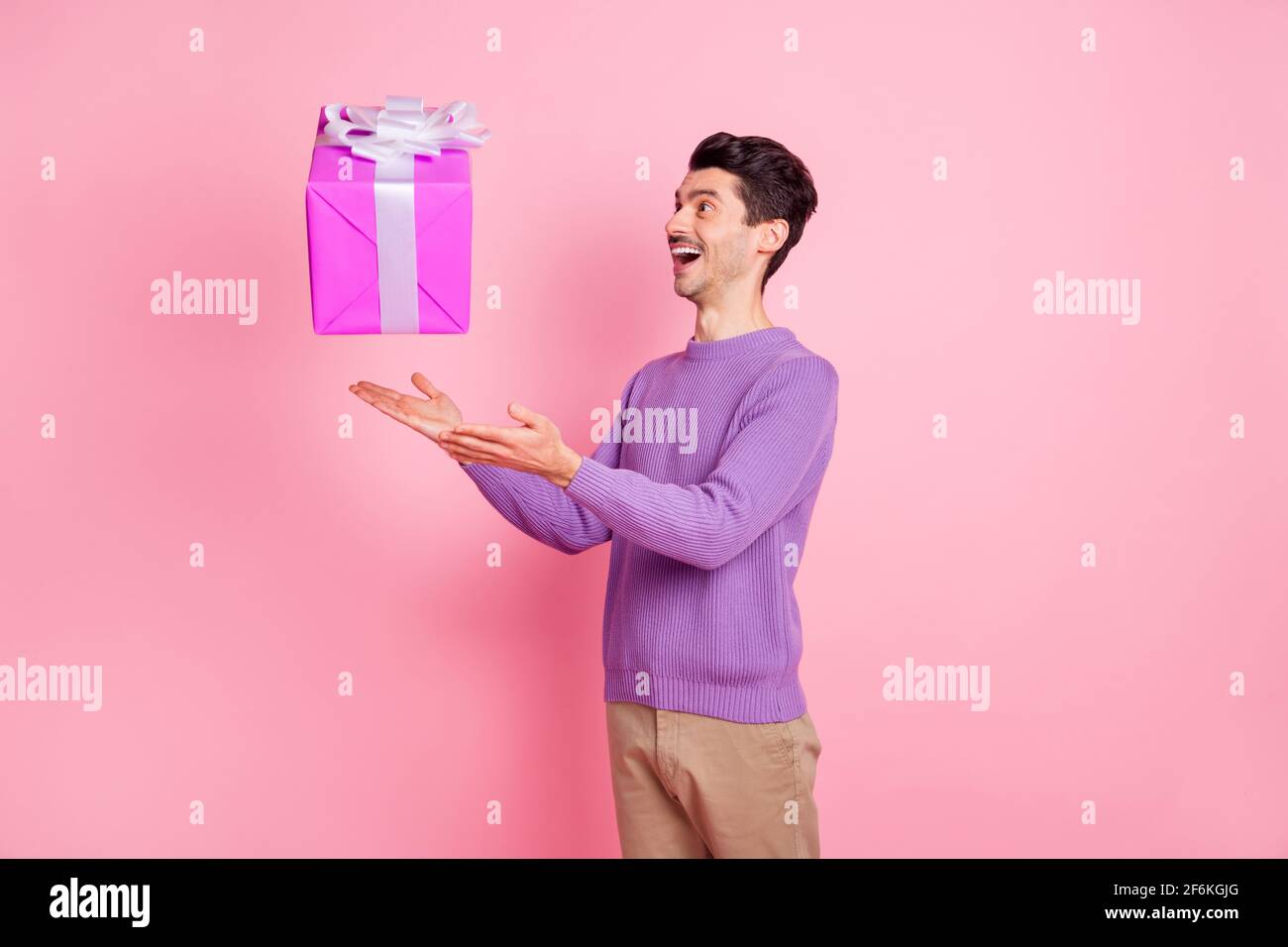 Photo of impressed positive young guy wear violet sweater catching ...