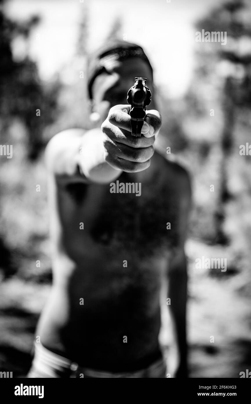Close-up on a boy's hand holding a gun in his hand. Serial killer ...