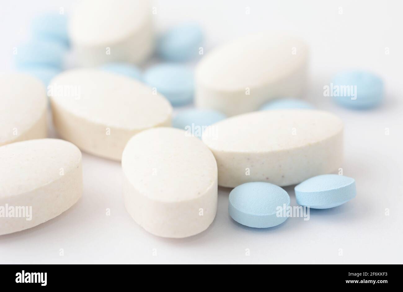 A close up of group of pills on white background Stock Photo - Alamy