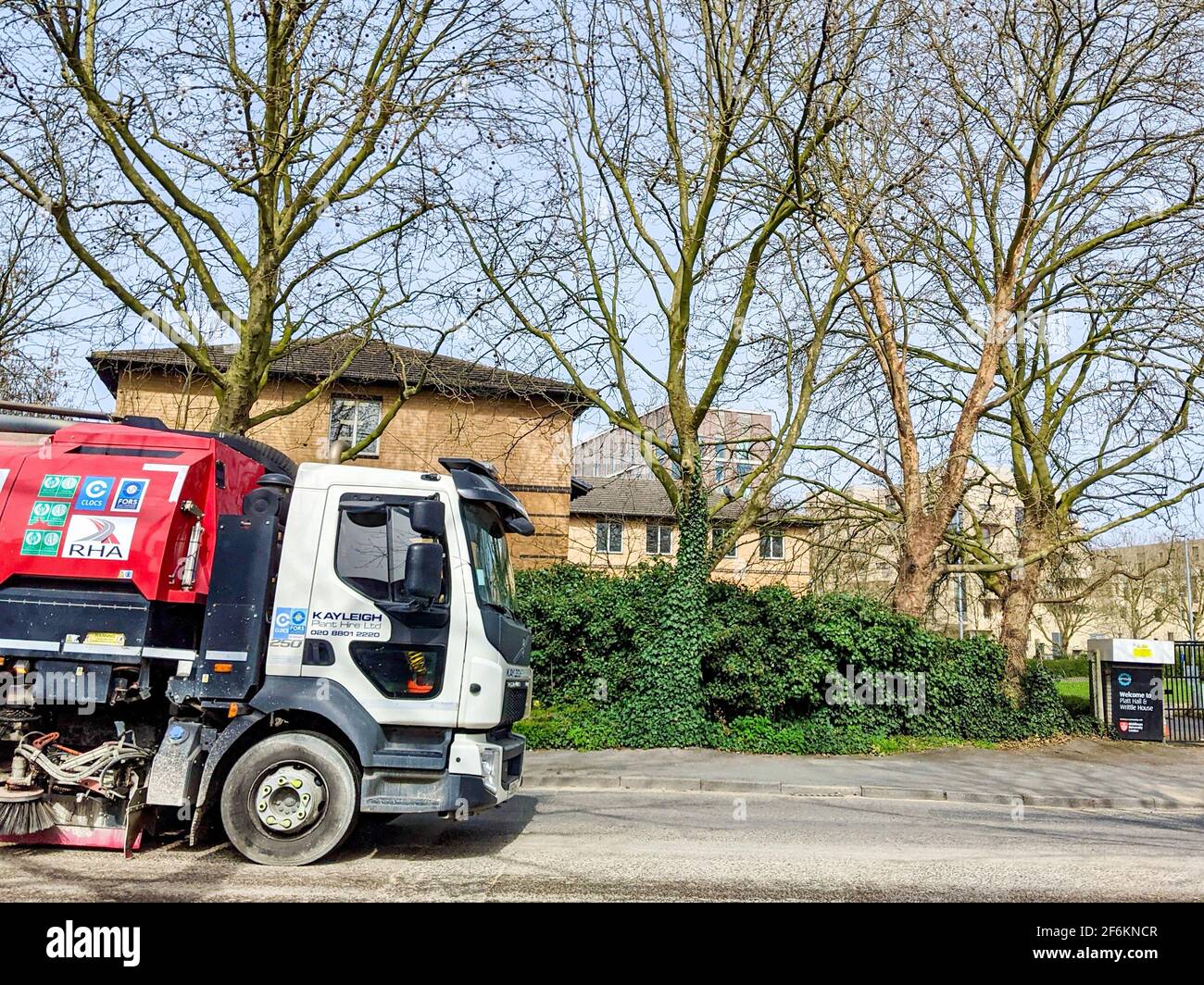 A red and white street sweeper cleaning vehicle for cleaning debris ...