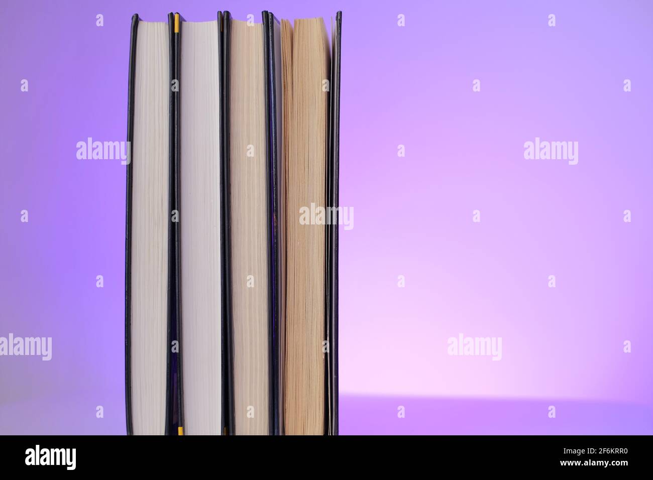 Books stack on purple background.Reading books.Learning concept Stock ...