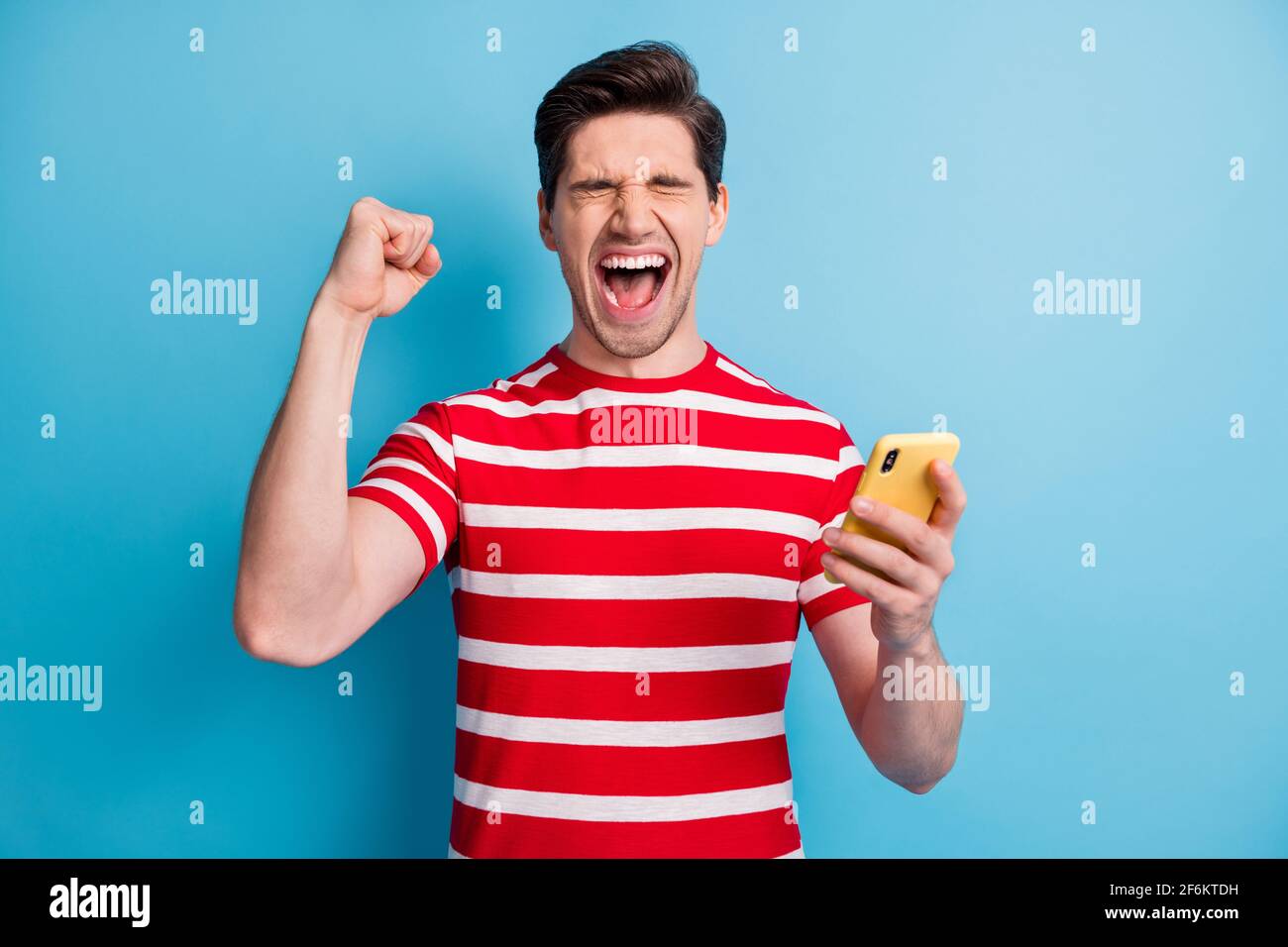 Photo portrait of overjoyed man gesturing like winner closed eyes ...