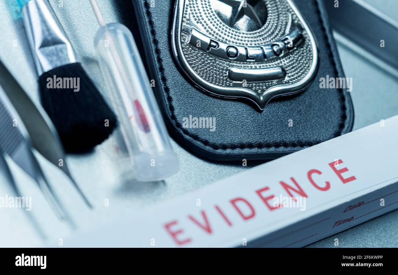 Police badge next to tools in crime lab, conceptual image Stock Photo ...