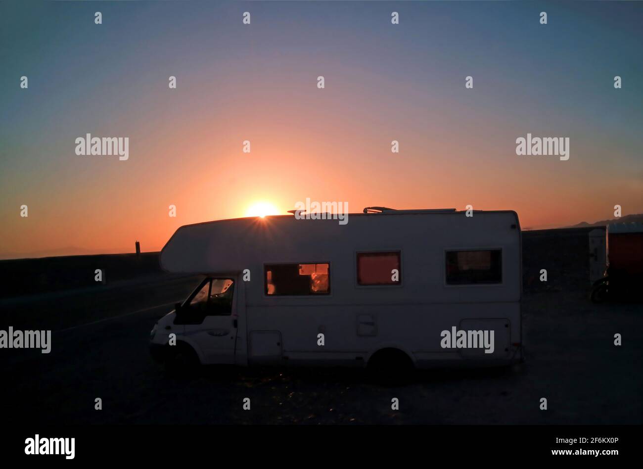 The bright sun setting over the camper van Stock Photo - Alamy