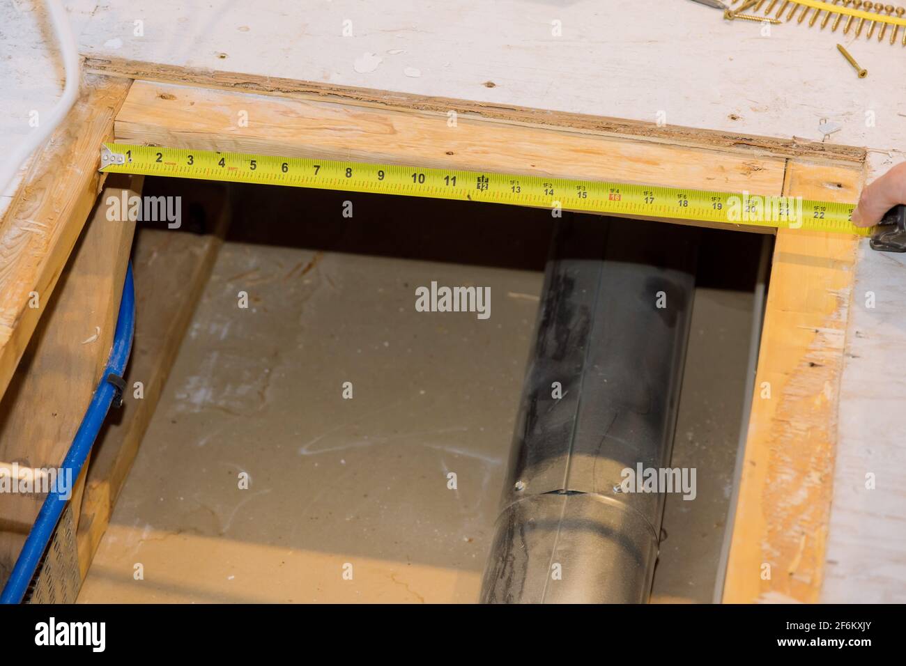 Carpentry work man in measures a for wooden beam on under construction ...