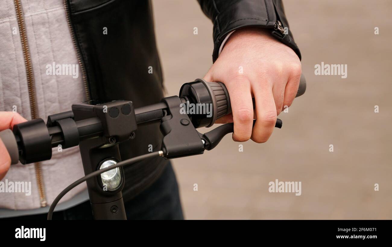 Electric scooter handlebar and man hand on the lever Stock Photo - Alamy