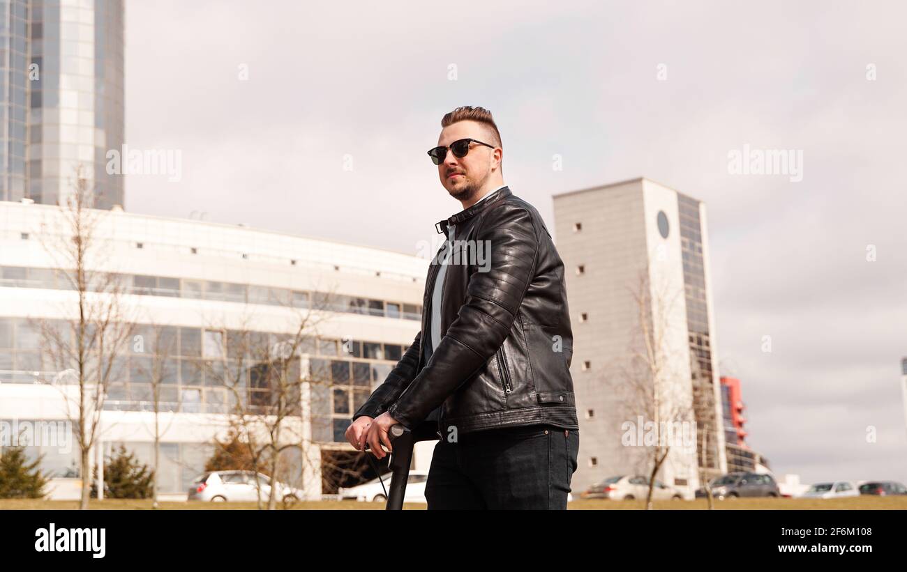 Modern man riding electric scooter in the city Stock Photo - Alamy