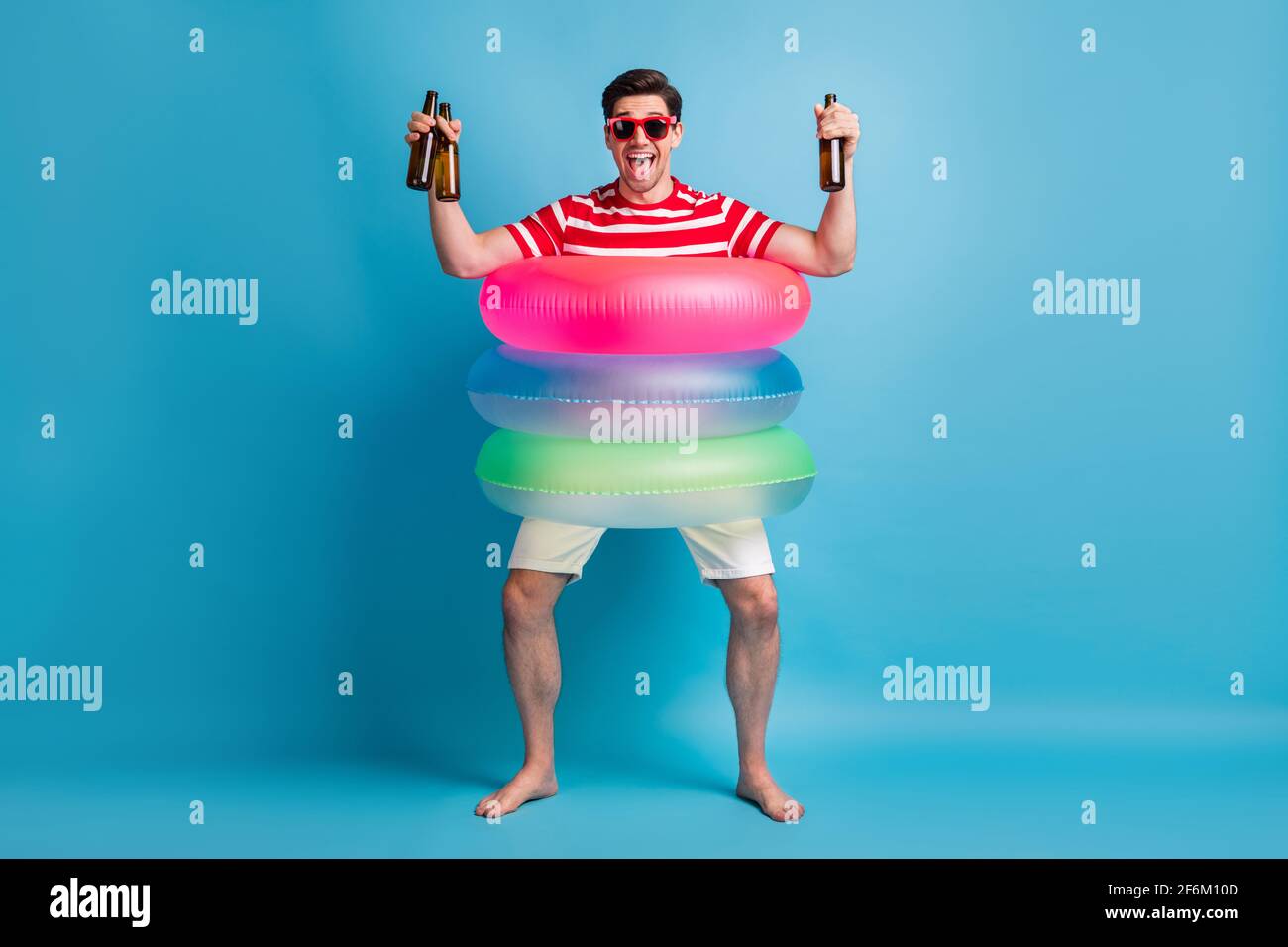 Full length body photo happy man going wearing colorful rubber circles ...