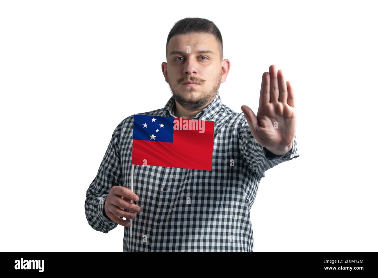 White guy holding a flag of Samoa and with a serious face shows a hand ...