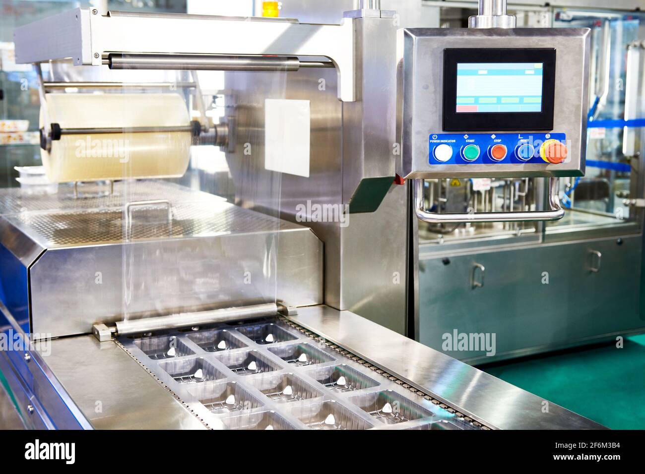 Conveyor at food factory for packing plastic containers Stock Photo - Alamy