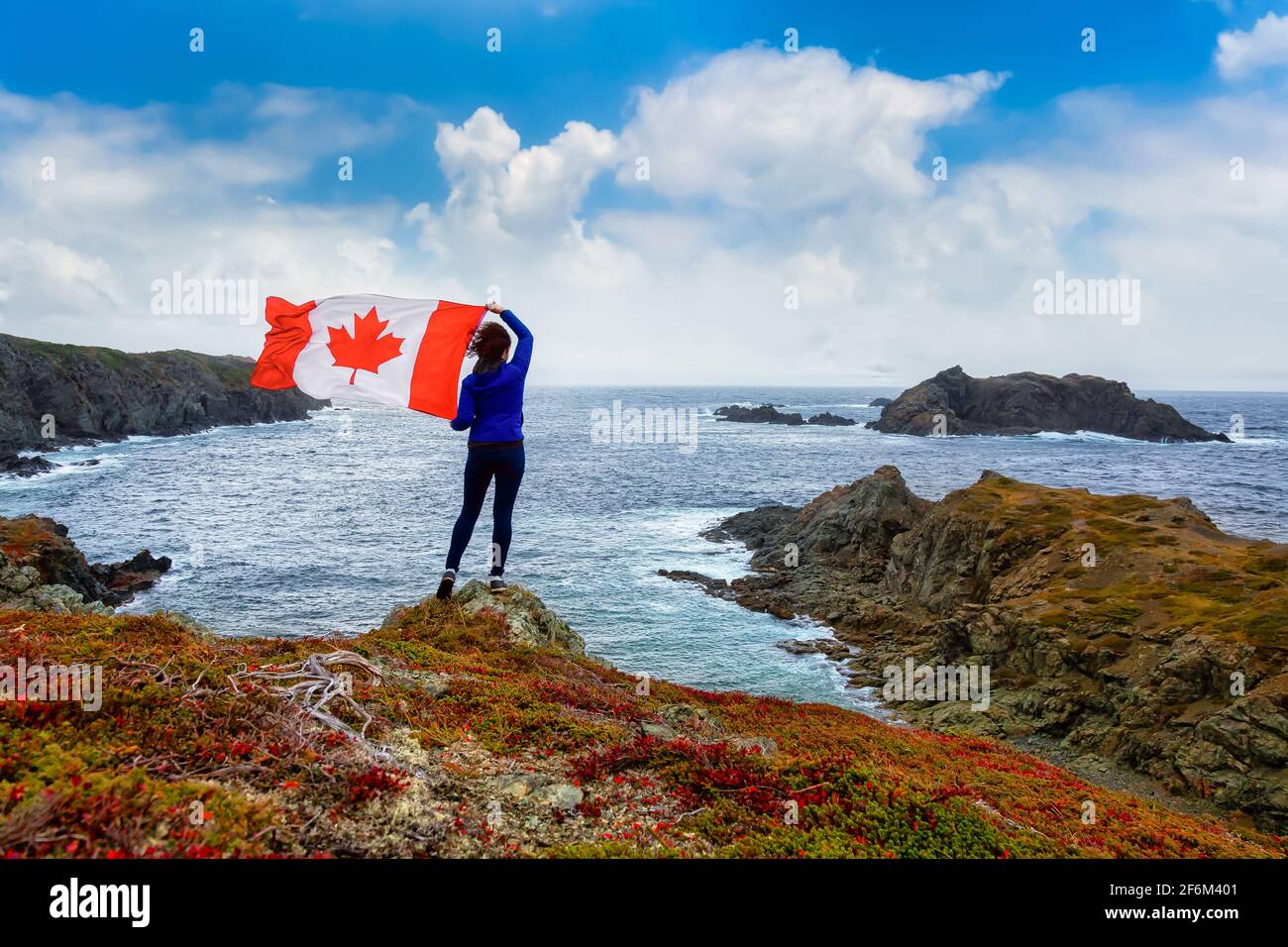 Adventurous woman holding a Canadian Flag Stock Photo - Alamy