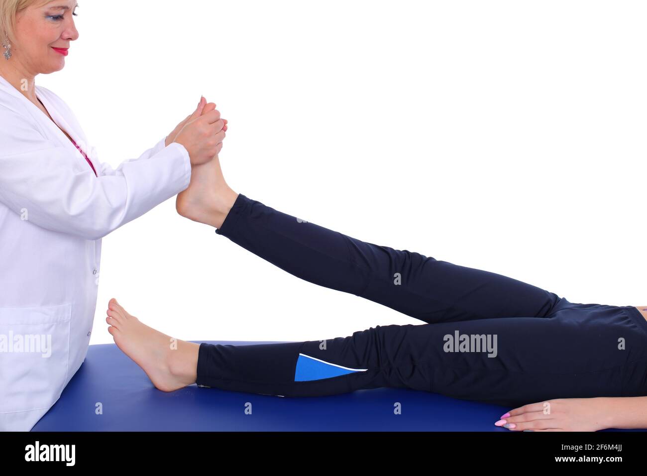 A physiotherapist performs a relaxing massage on the muscles of the ...