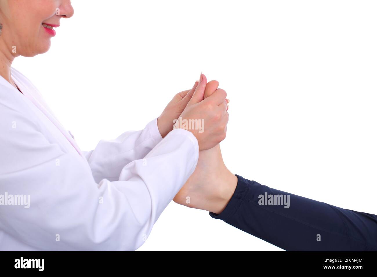 A physiotherapist performs a relaxing massage on the muscles of the ...