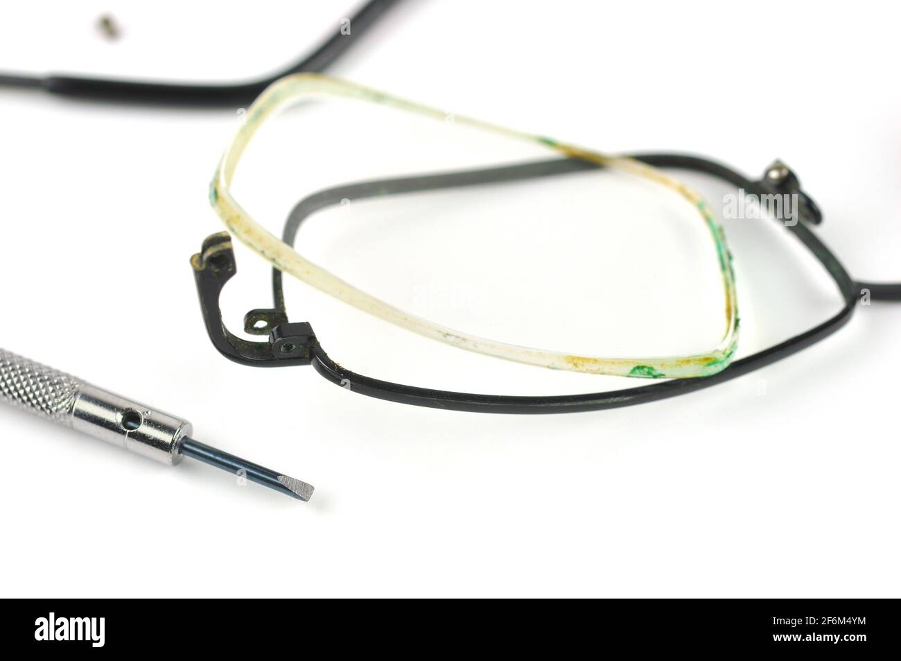 Broken Eyeglasses and screwdriver on white background. Eyeglasses ...