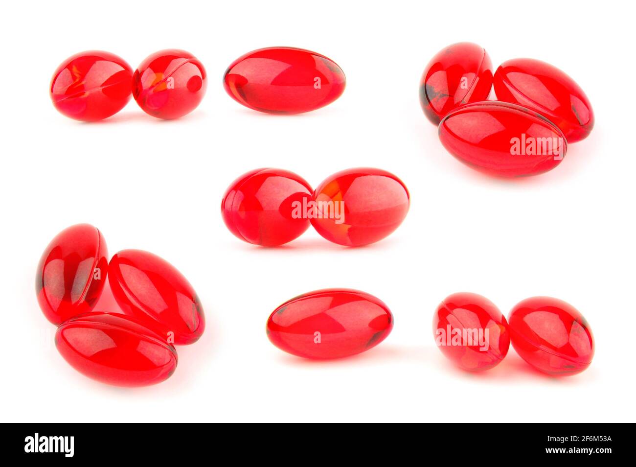 Red vitamin pills closeup isolated on white background Stock Photo - Alamy