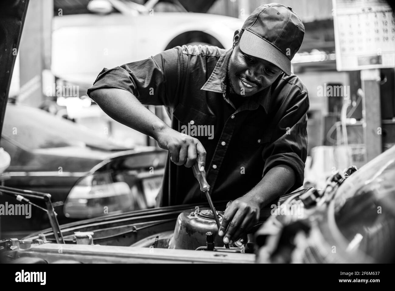 African maintenance male checking tire service via insurance system at ...
