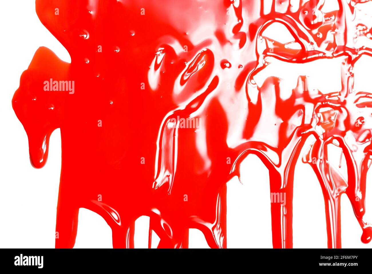 Thick red paint on a white background. Paint flows Stock Photo - Alamy