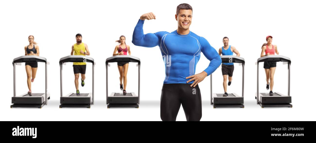 Bodybuilder flexing muscle and people running on treadmills in the back ...