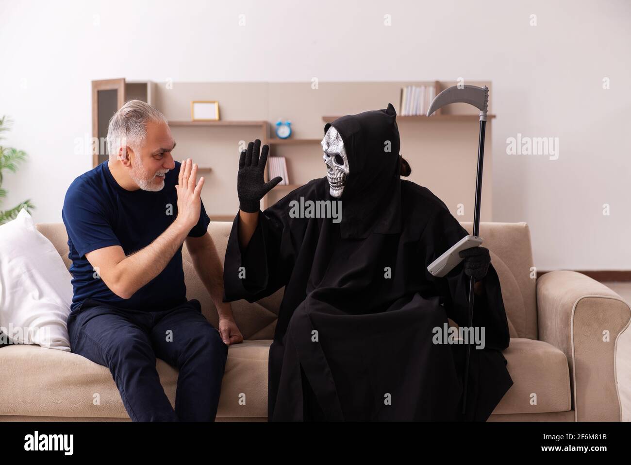 Devil coming to old dying man Stock Photo - Alamy