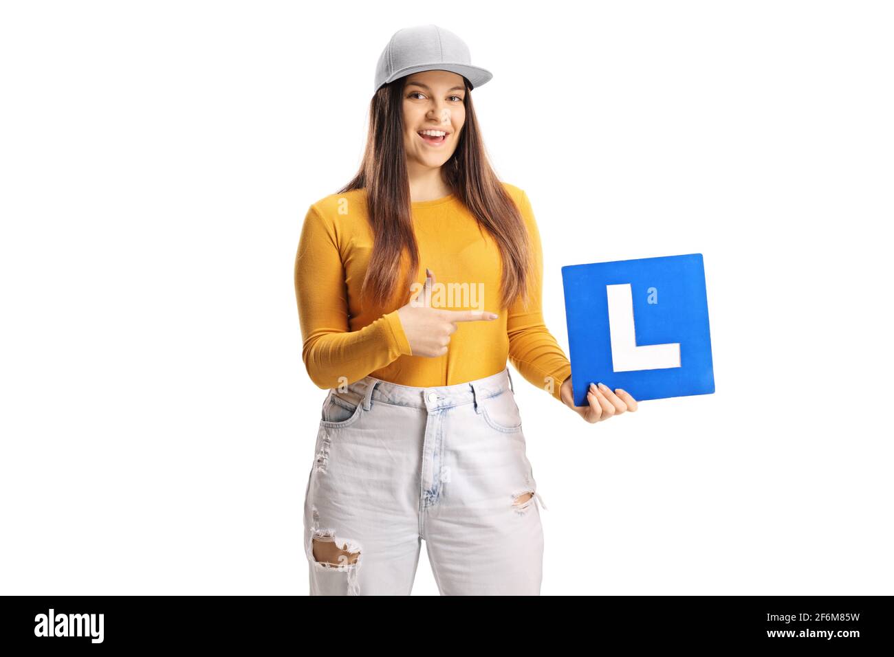Young female driver holding a learner plate isolated on white ...