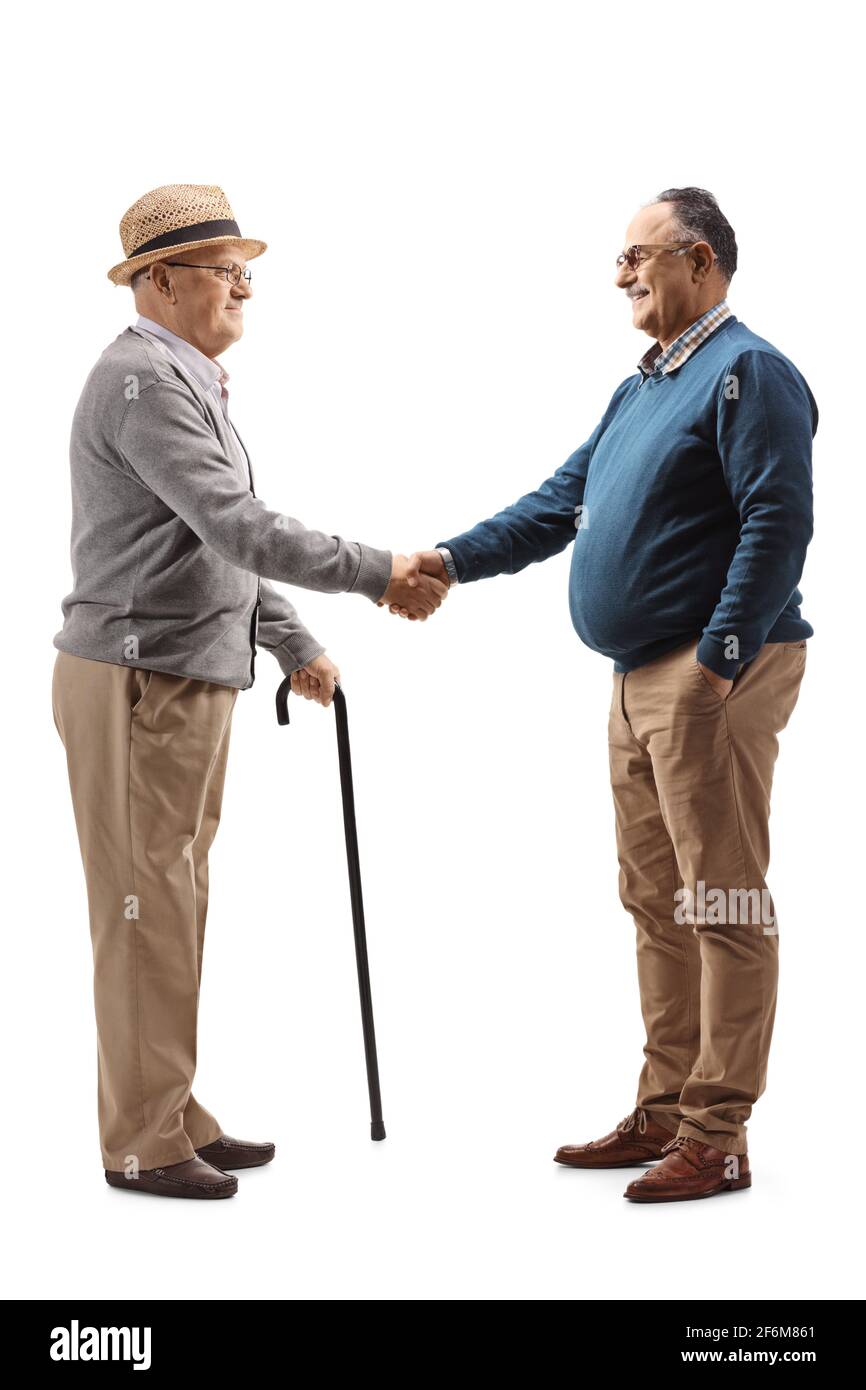 Full length profile shot of a mature and elderly an shaking hands ...