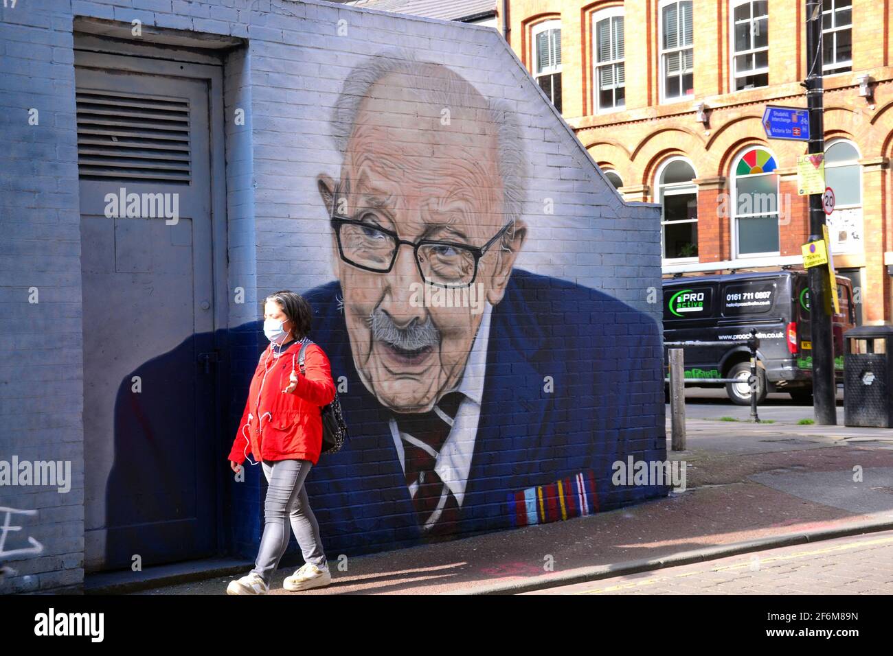 A woman walks in front of a newly created street art painting of ...