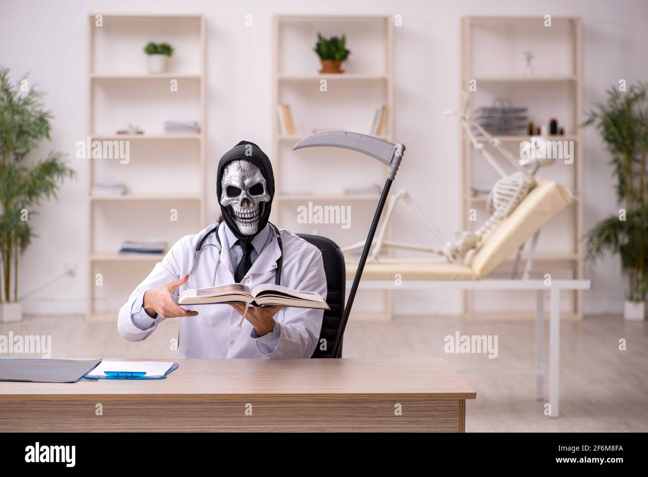 Reaper grim doctor examining skeleton patient in the clinic Stock Photo ...