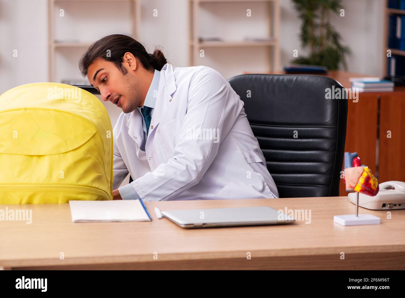 Young male doctor looking after new born at the hospital Stock Photo ...
