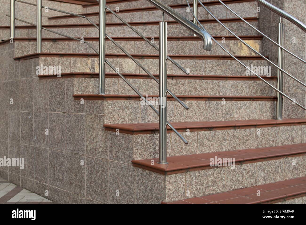 Horizontal steps made of brown ceramic tiles turning stairs made of ...