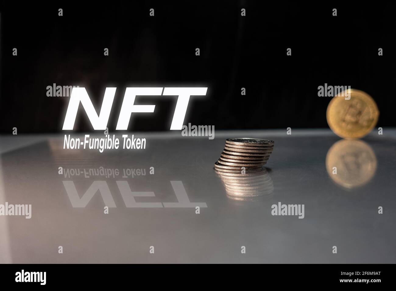 Non-fungible token and NFT words on black background with coin, cyrpto ...