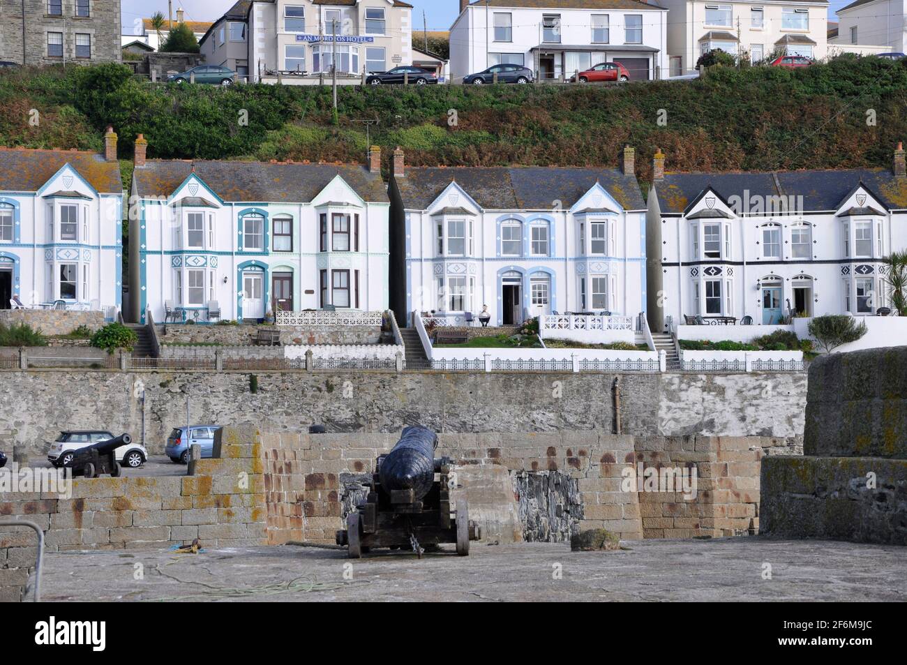 A row of Victorian houses overlooking the harbour with cannon on the ...