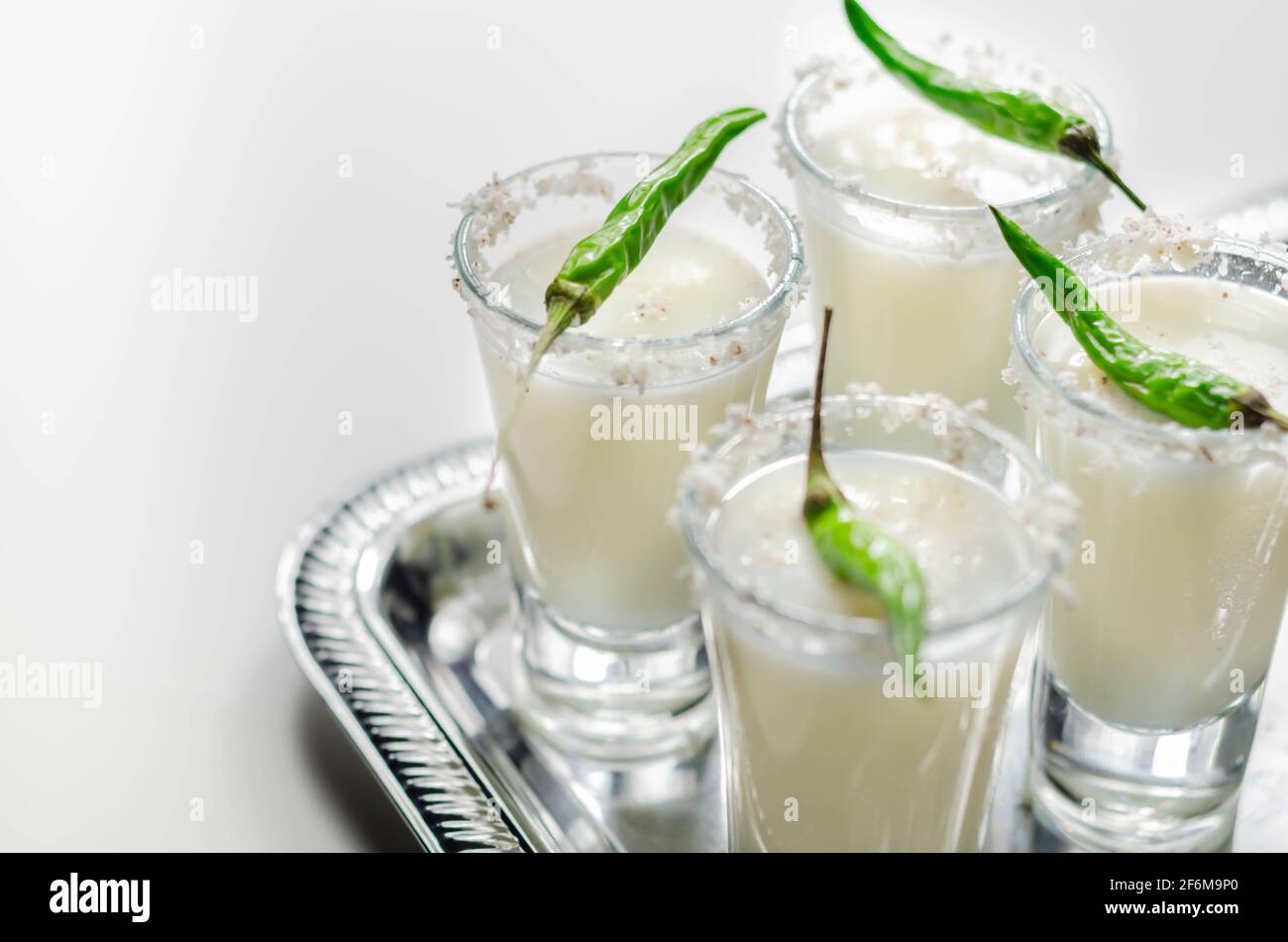 Coconut cocktail in drink shot glass decorated with coconut flakes and ...