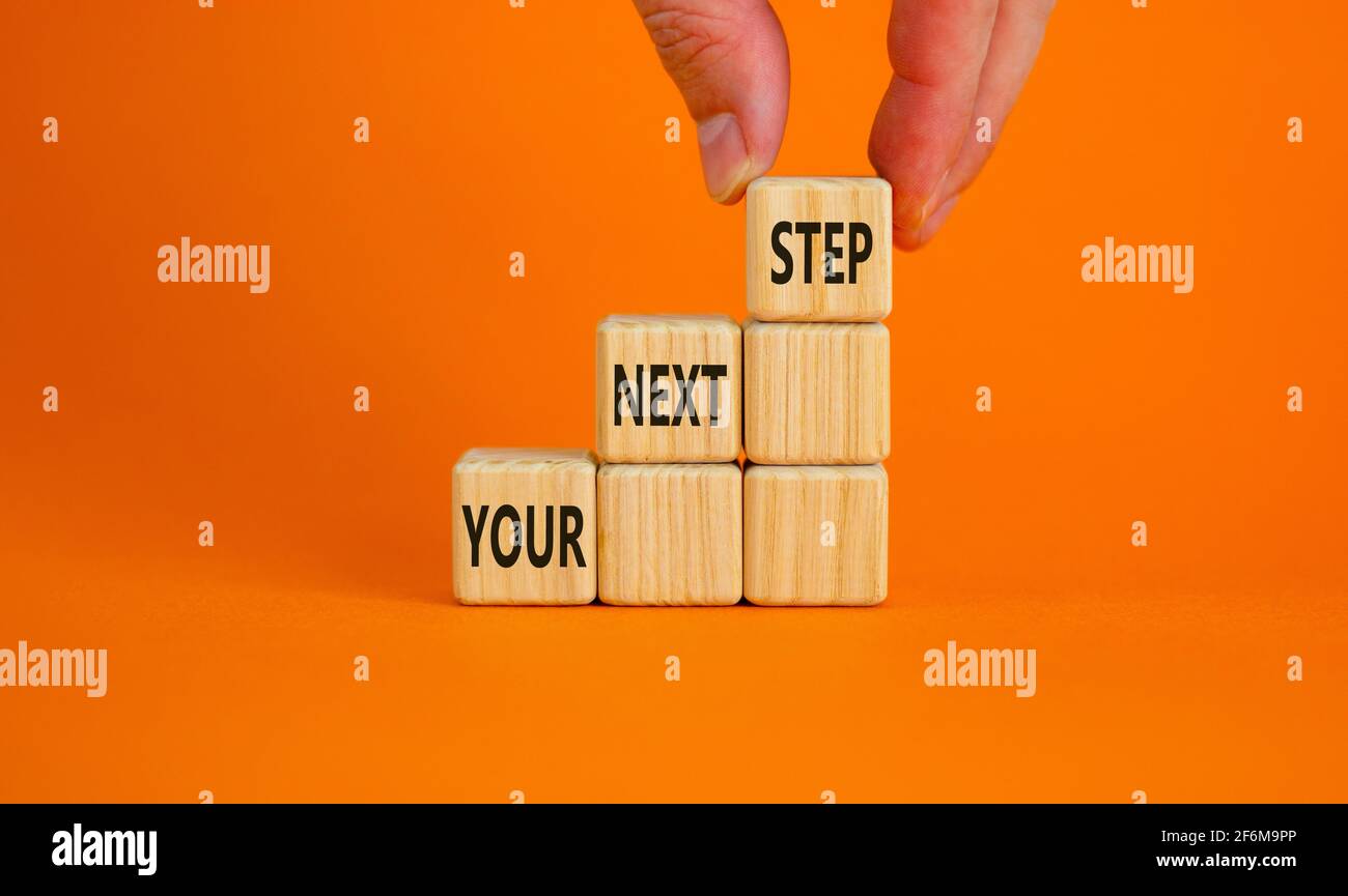 Your next step symbol. Hand arranging wood block stacking as step stair ...